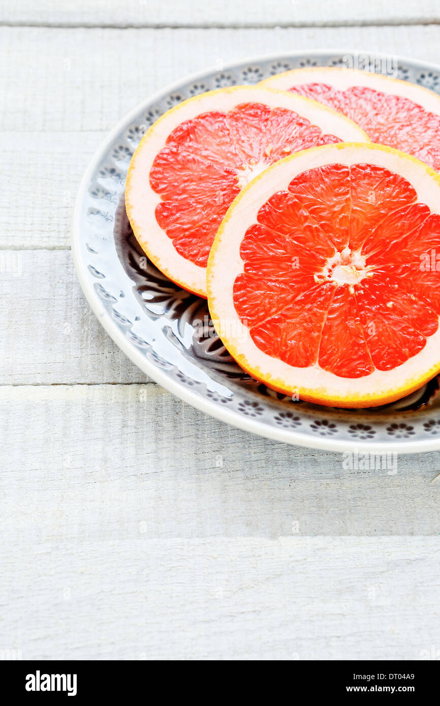 Sliced grapefruit on a plate, food closeup Stock Photo - Alamy