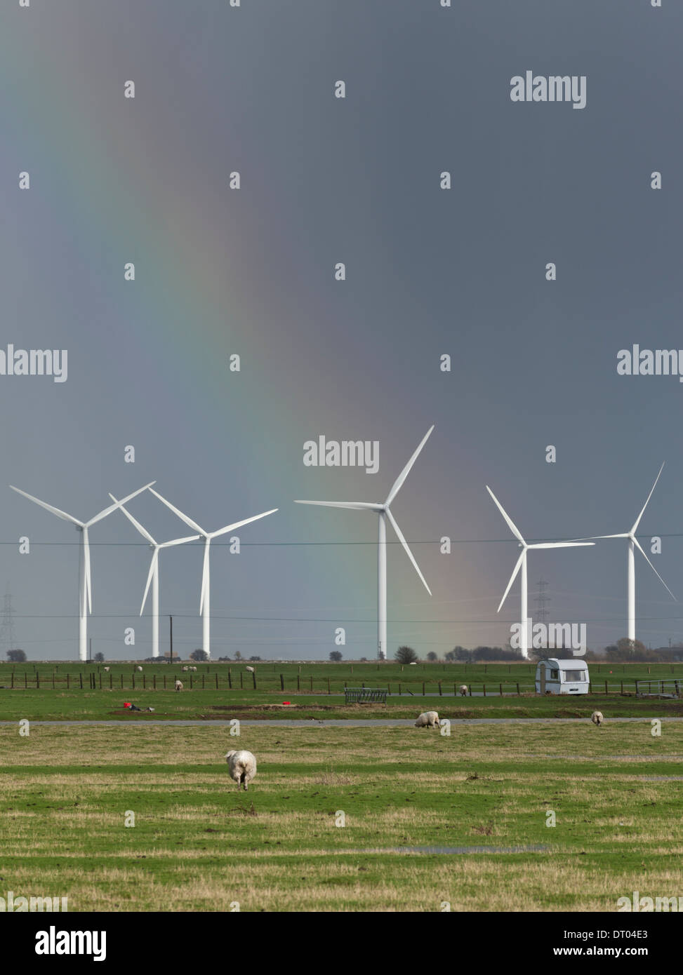 A rainbow shining directly onto a wind turbine at the Little Cheyne ...