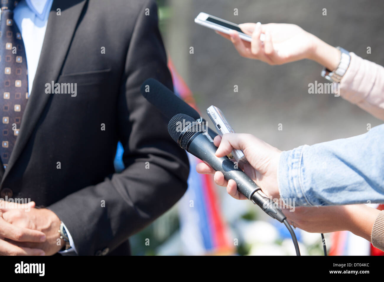 interview with media microphone held in front of businessman, spokesman ...