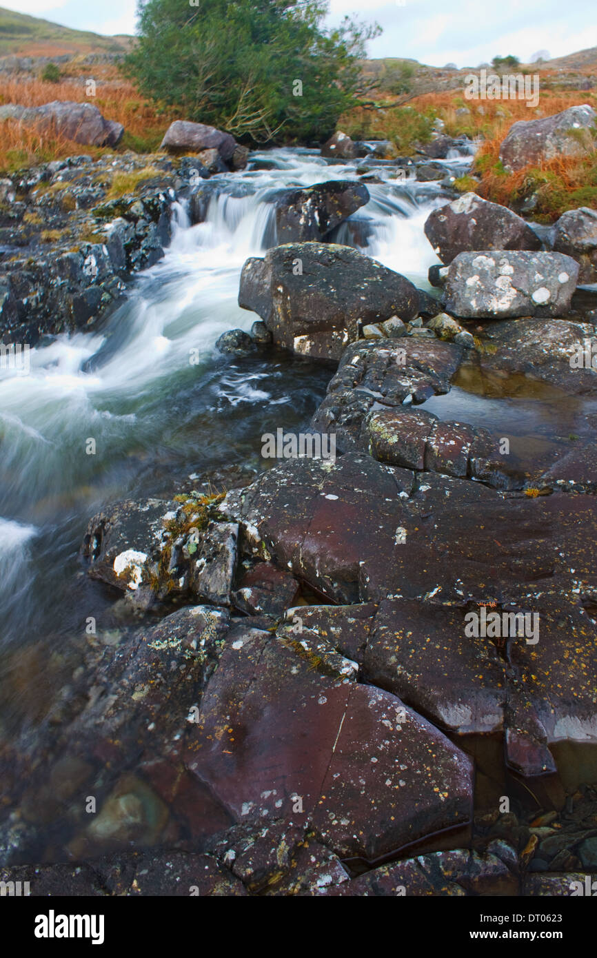 Red gritstone rocks in the riverbed along the Afon Artro, Rhinogydd ...
