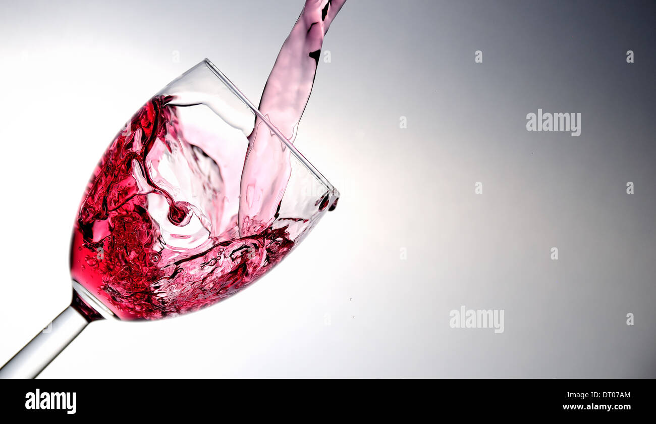 Glass of wine being poured Stock Photo - Alamy