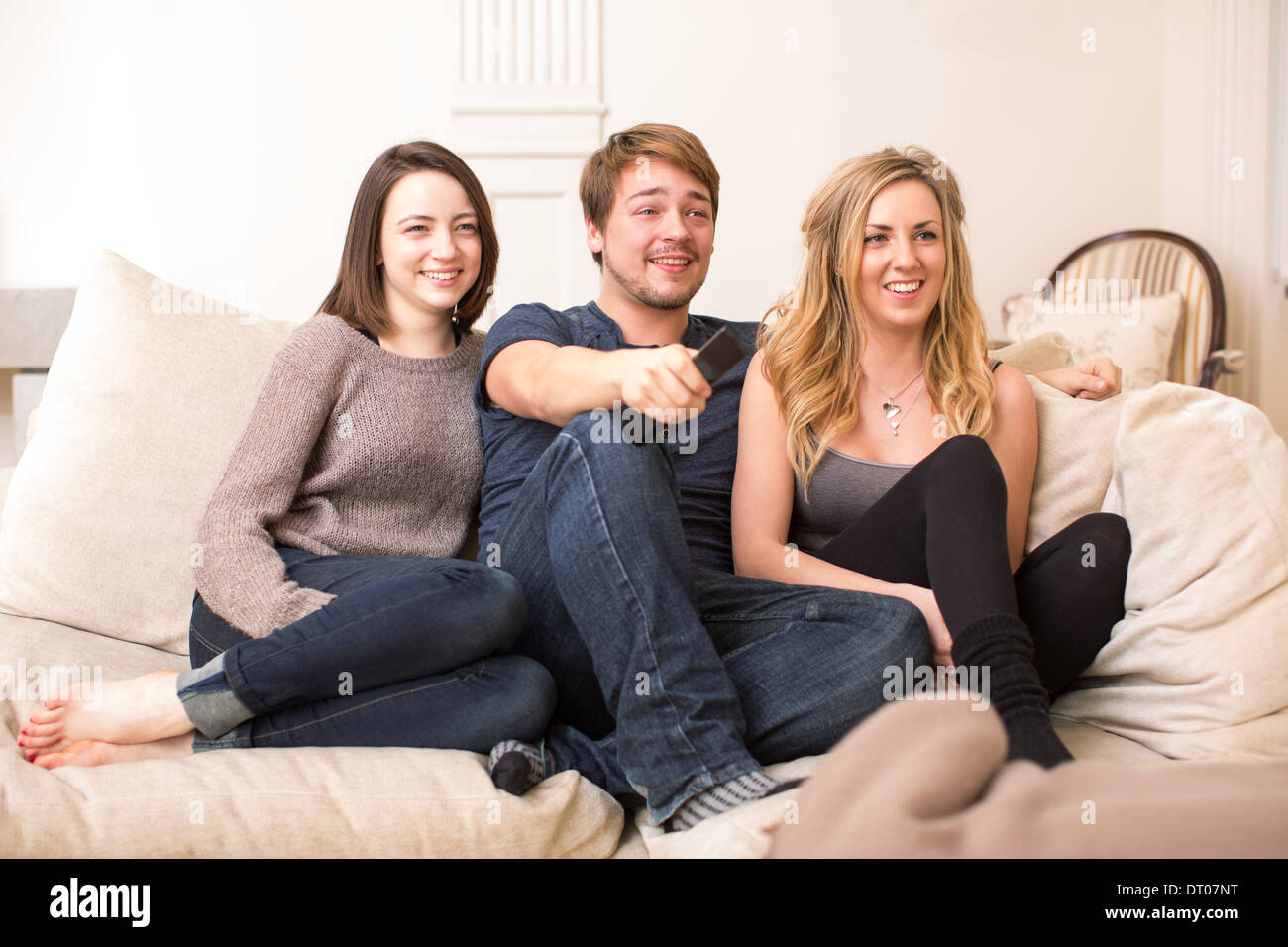Three students watching TV Stock Photo - Alamy