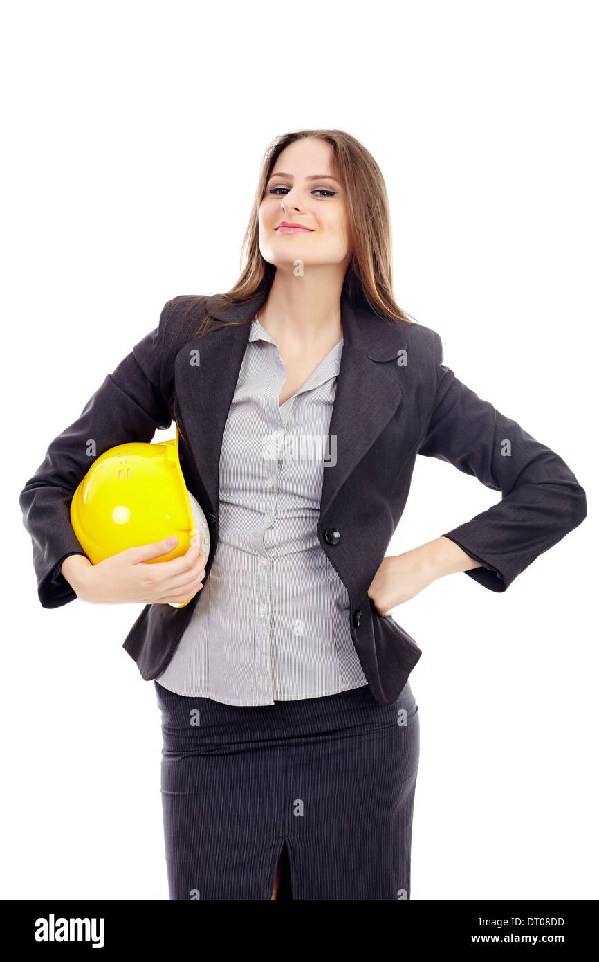 Young attractive female engineer holding a helmet with hand on waist ...