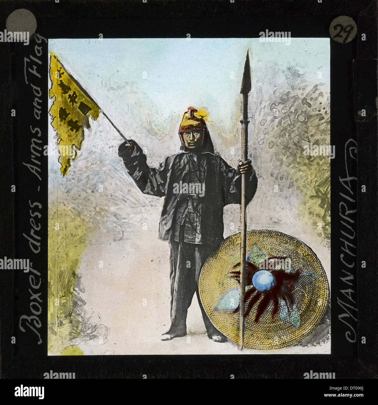 A Chinese Boxer, standing with arms raised and a flag, captured during ...