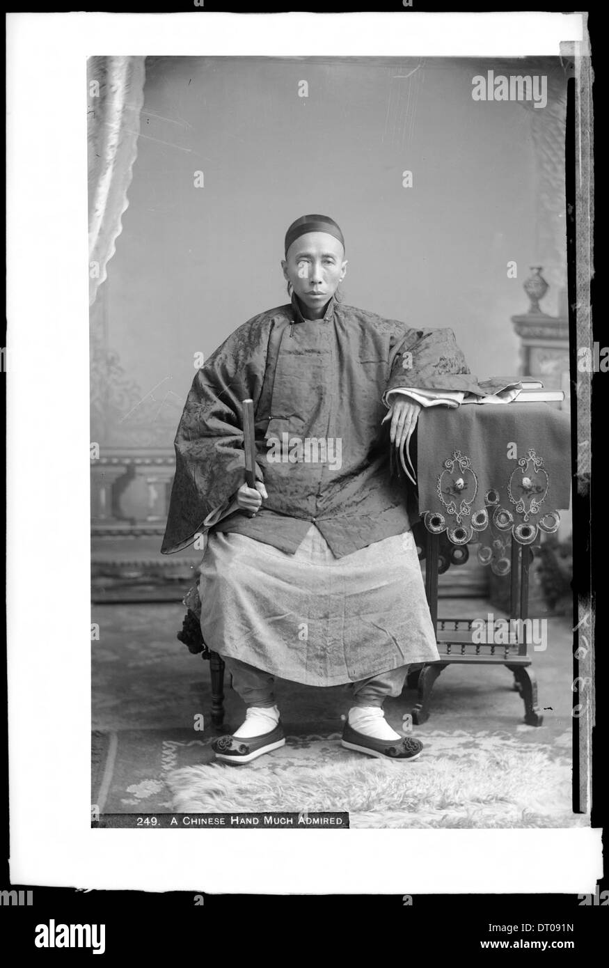 A portrait of a Chinese doctor with long fingernails, representing an ...