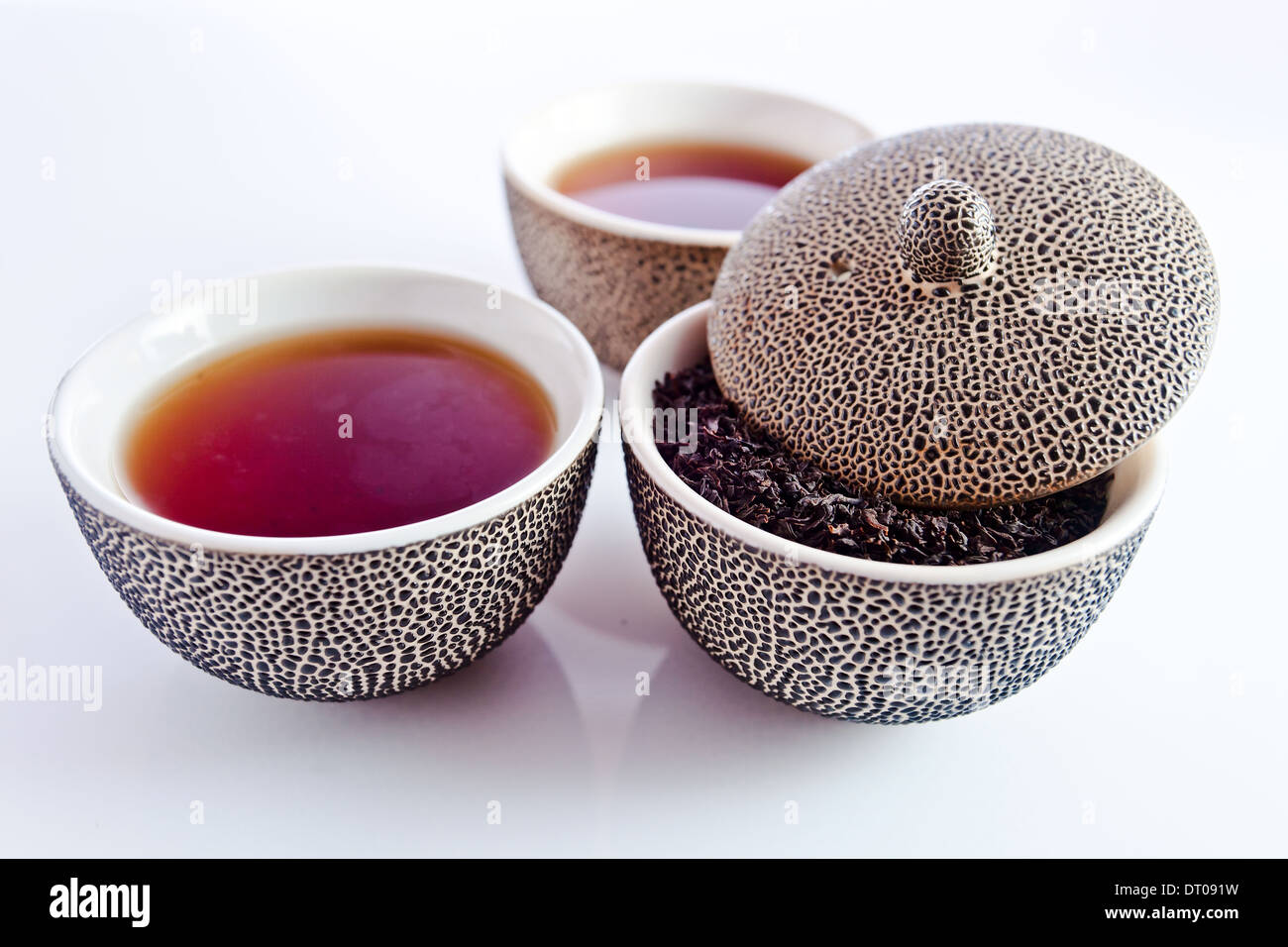 tea in small cups on a reflective background Stock Photo - Alamy