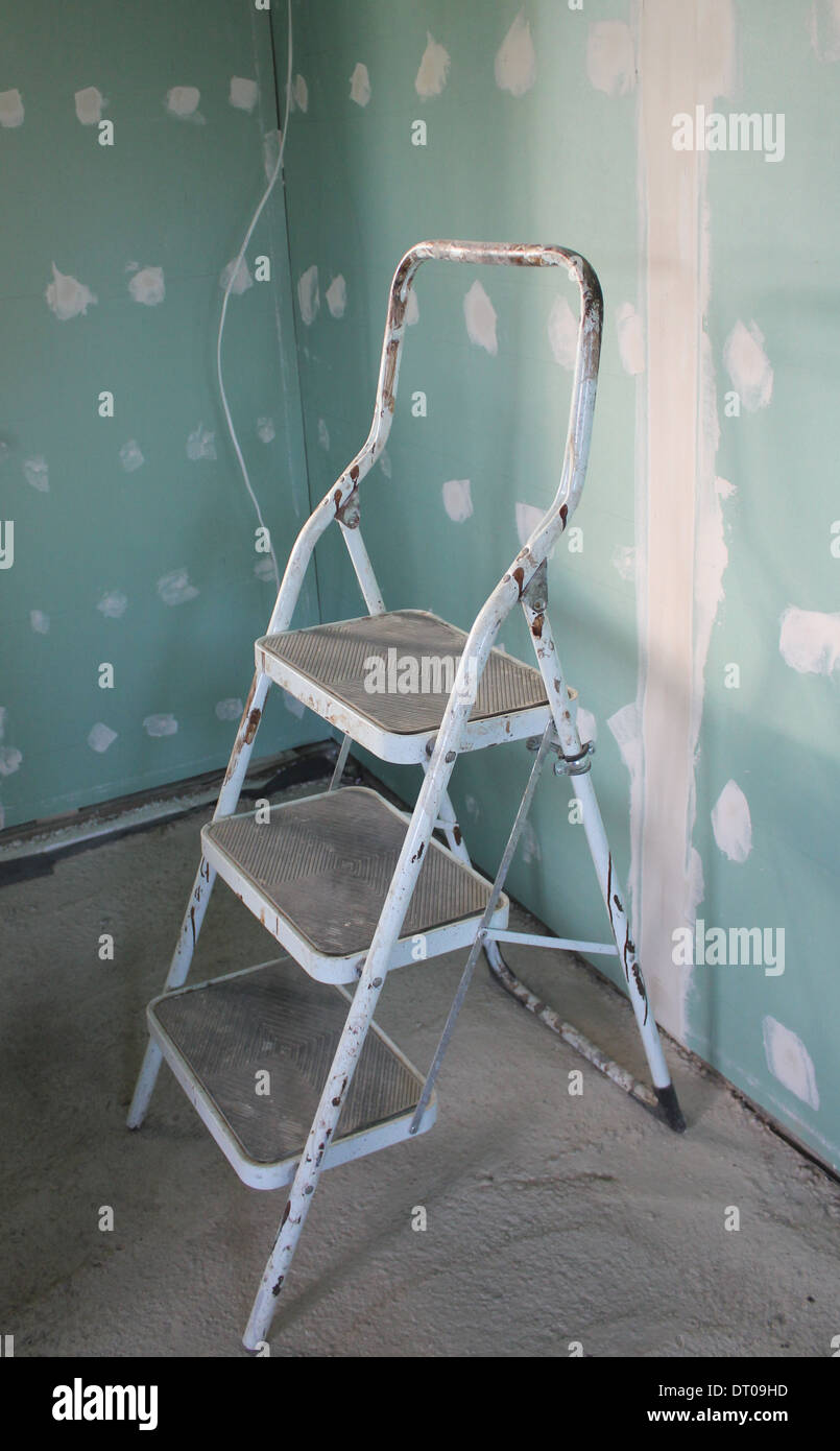 Step stool and wall daubed with plaster Stock Photo - Alamy