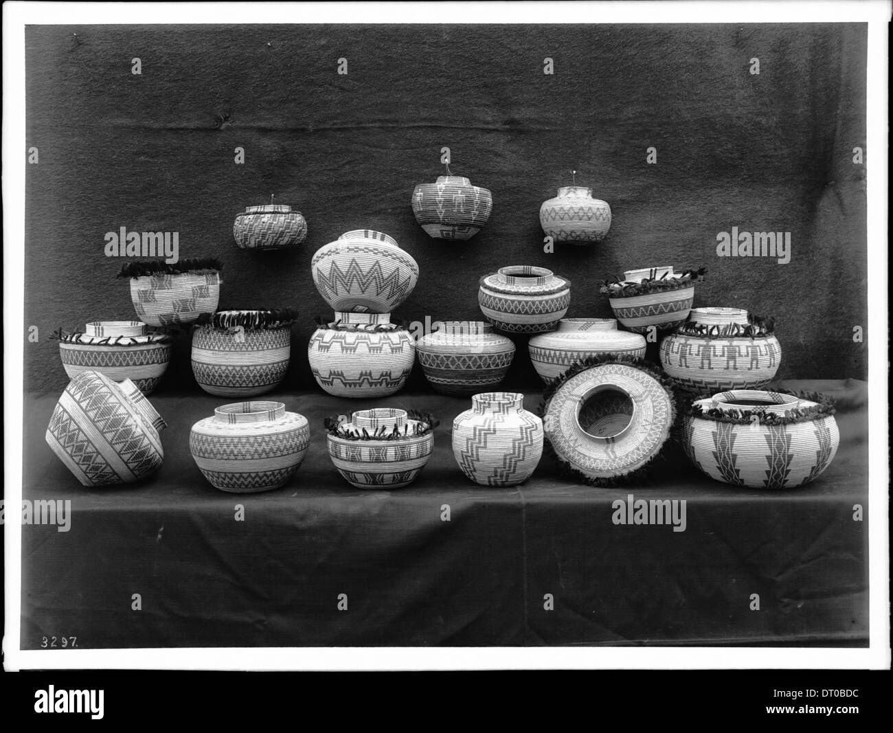 A collection of 19 Indian baskets on display, photographed around 1900 ...