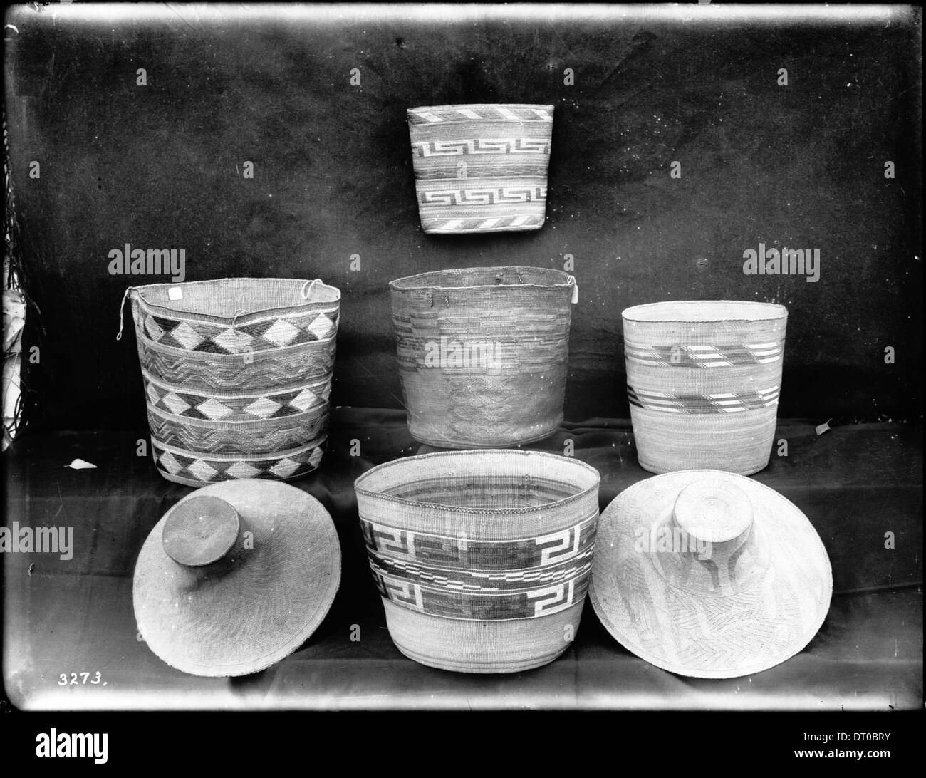 A collection of seven Walapai Indian baskets, displayed in a vintage ...