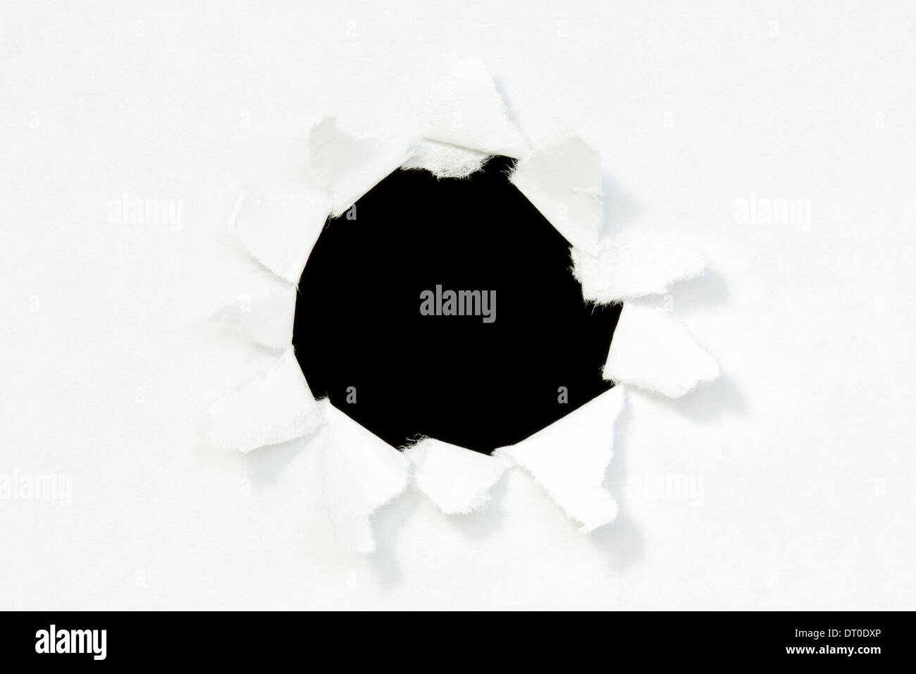 Hole in a paper with black background inside Stock Photo - Alamy