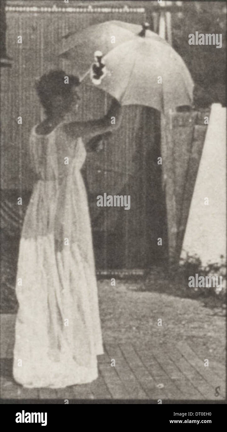 A draped woman is photographed opening a parasol and turning around in ...