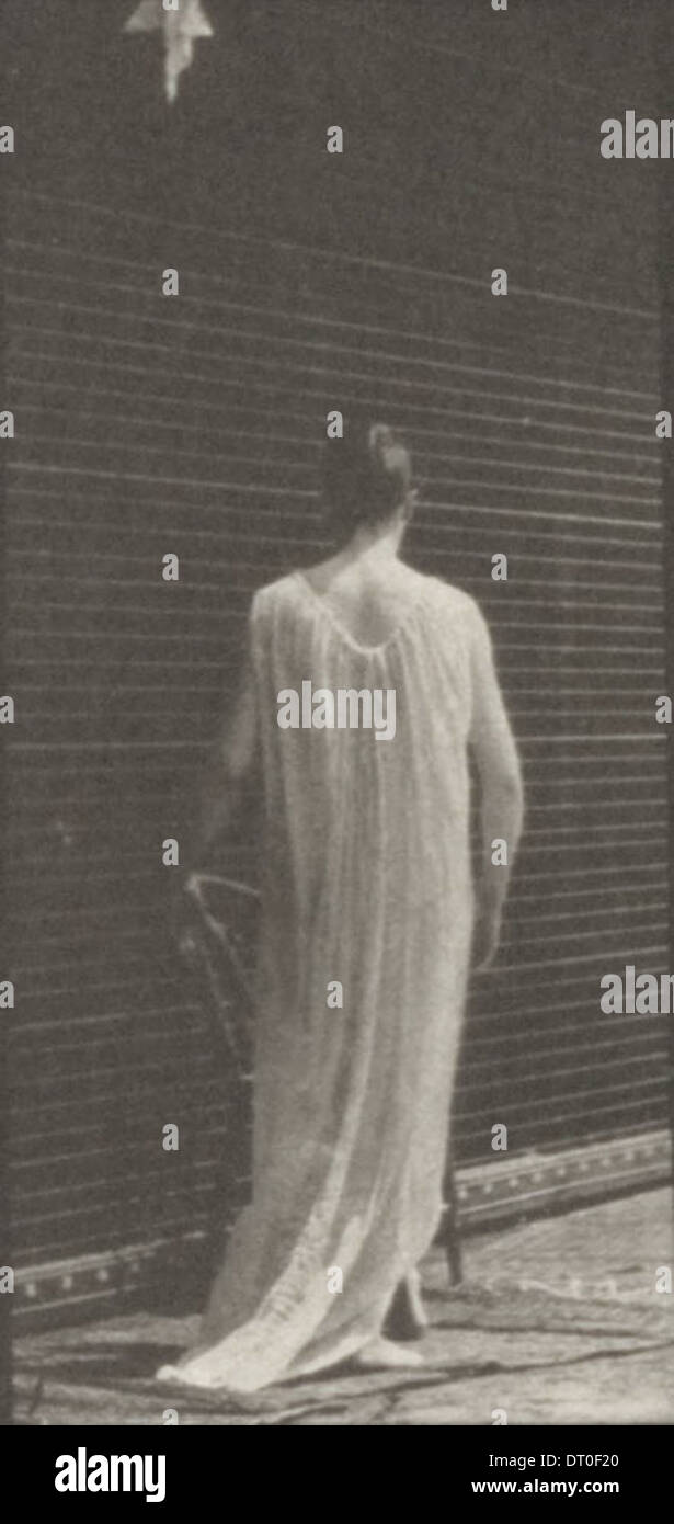 A draped woman steps onto a chair, reaching upwards and then descending ...