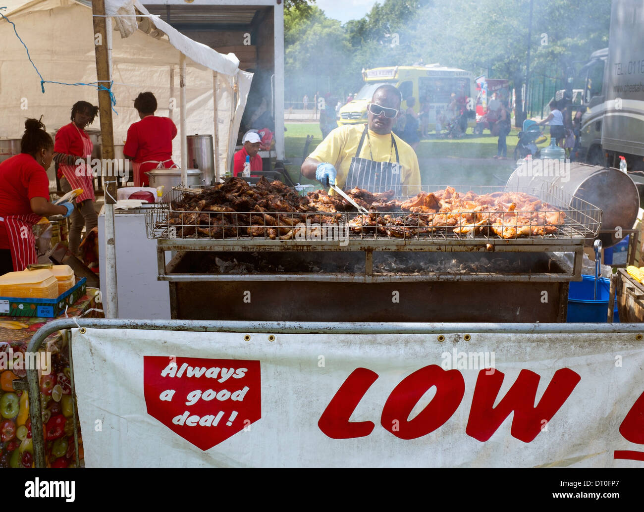 Black African Caribbean man cooking jerk chicken at Carnival Stock ...