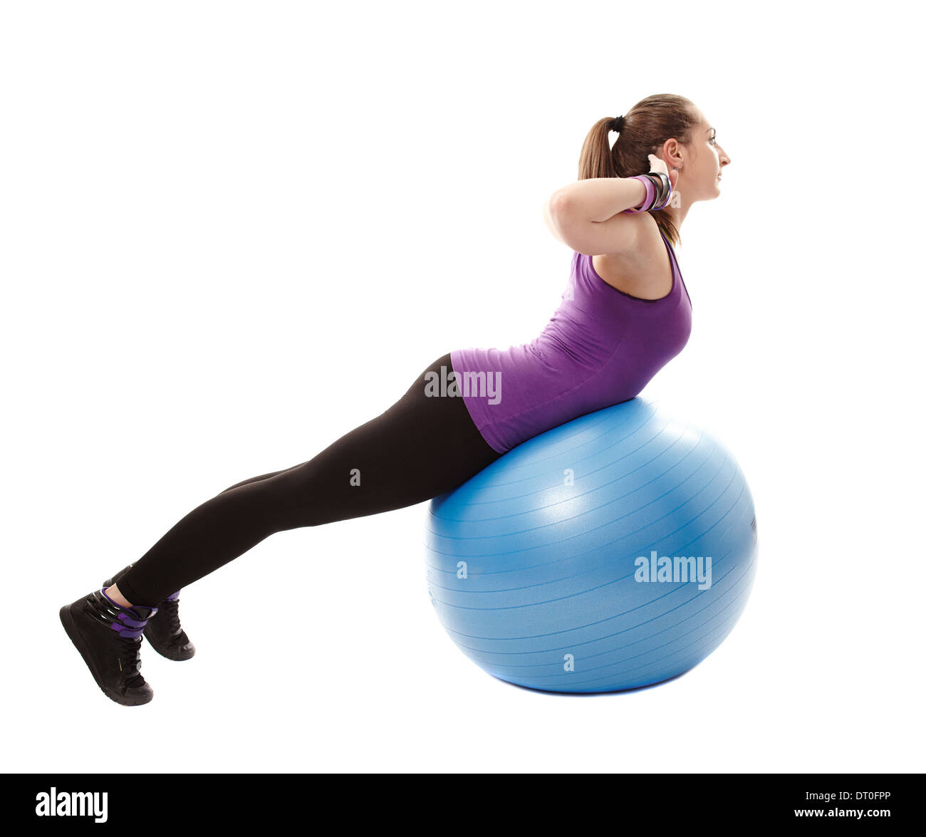 Studio shot of young athletic woman working her back muscles on the ...