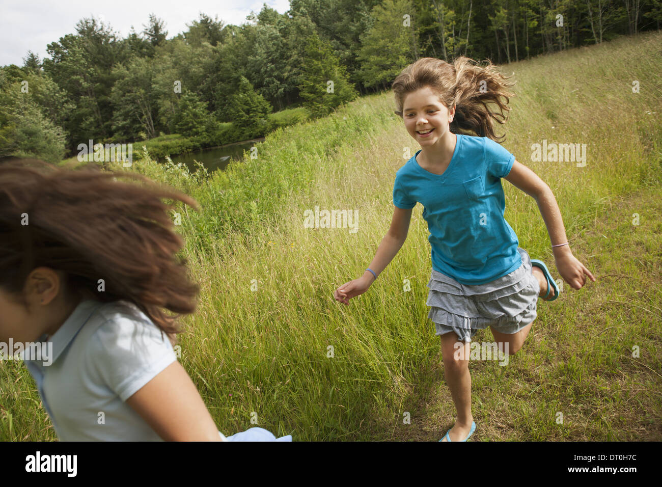 New York state USA Two children girl playing chase running along path ...
