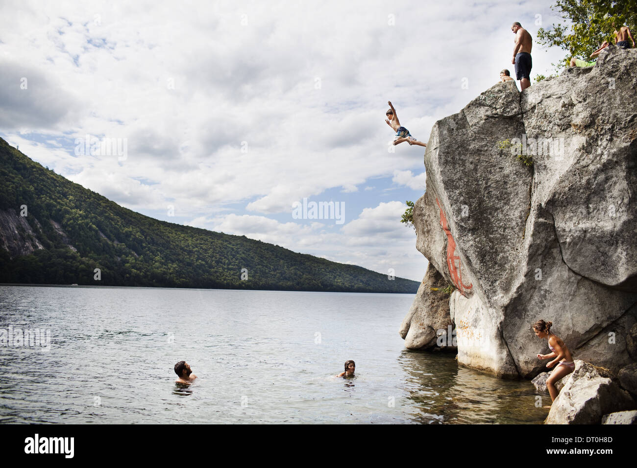 Massachusetts USA group of young people jumping from cliff lake Stock ...