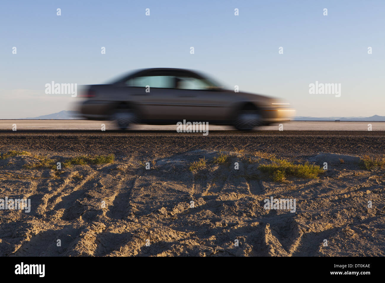 Bonneville Salt Flats Utah USA saloon car driving through the desert at ...