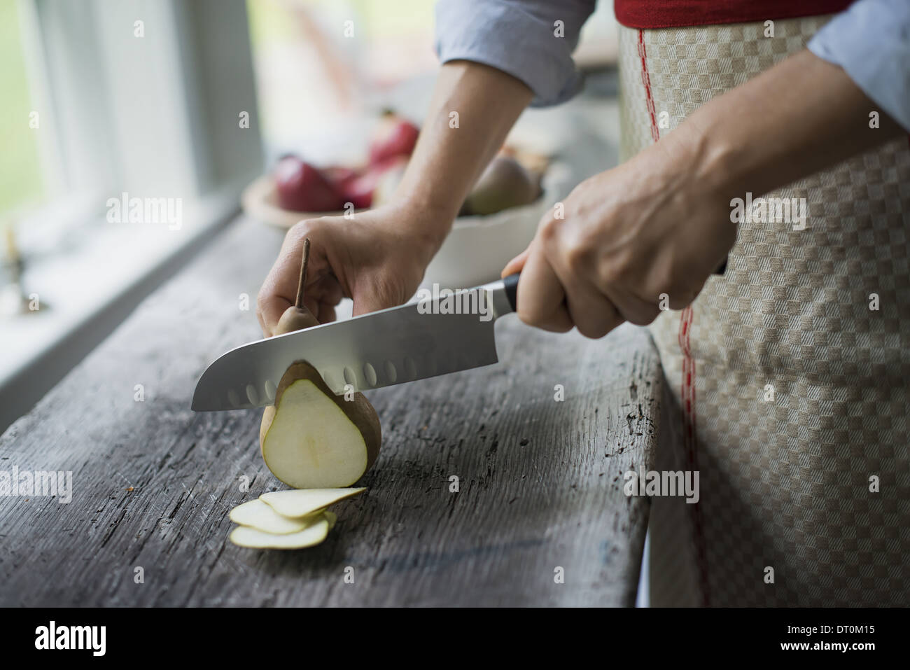 Woodstock New York USA woman slicing fresh picked fruit organic pear ...