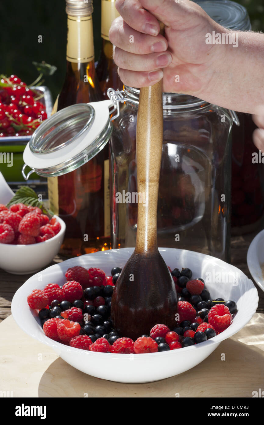 Crushed currants and raspberries for a fruit liqueur Stock Photo - Alamy