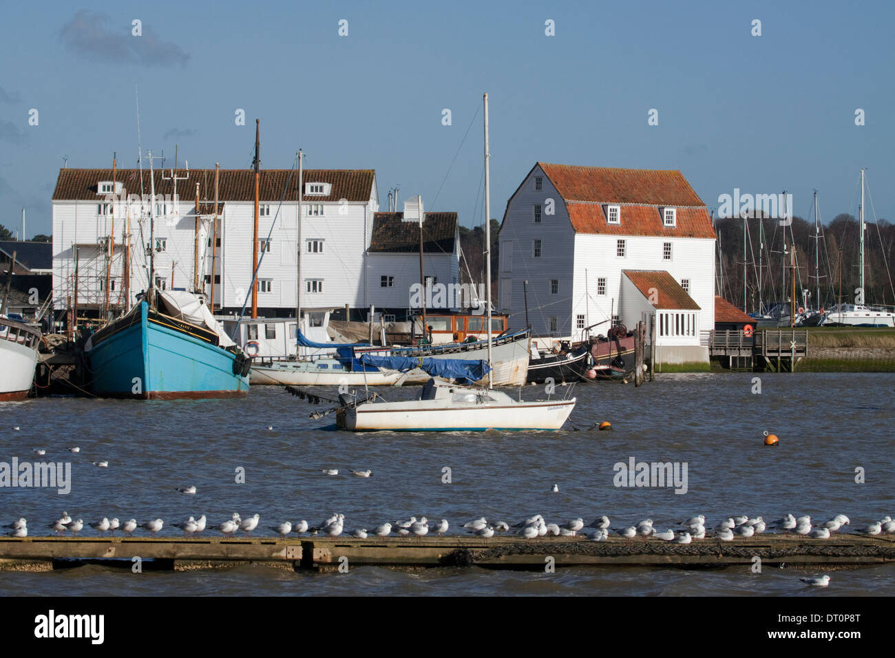 Woodbridge Tide Mill with boats and gulls resting on pontoon Stock ...