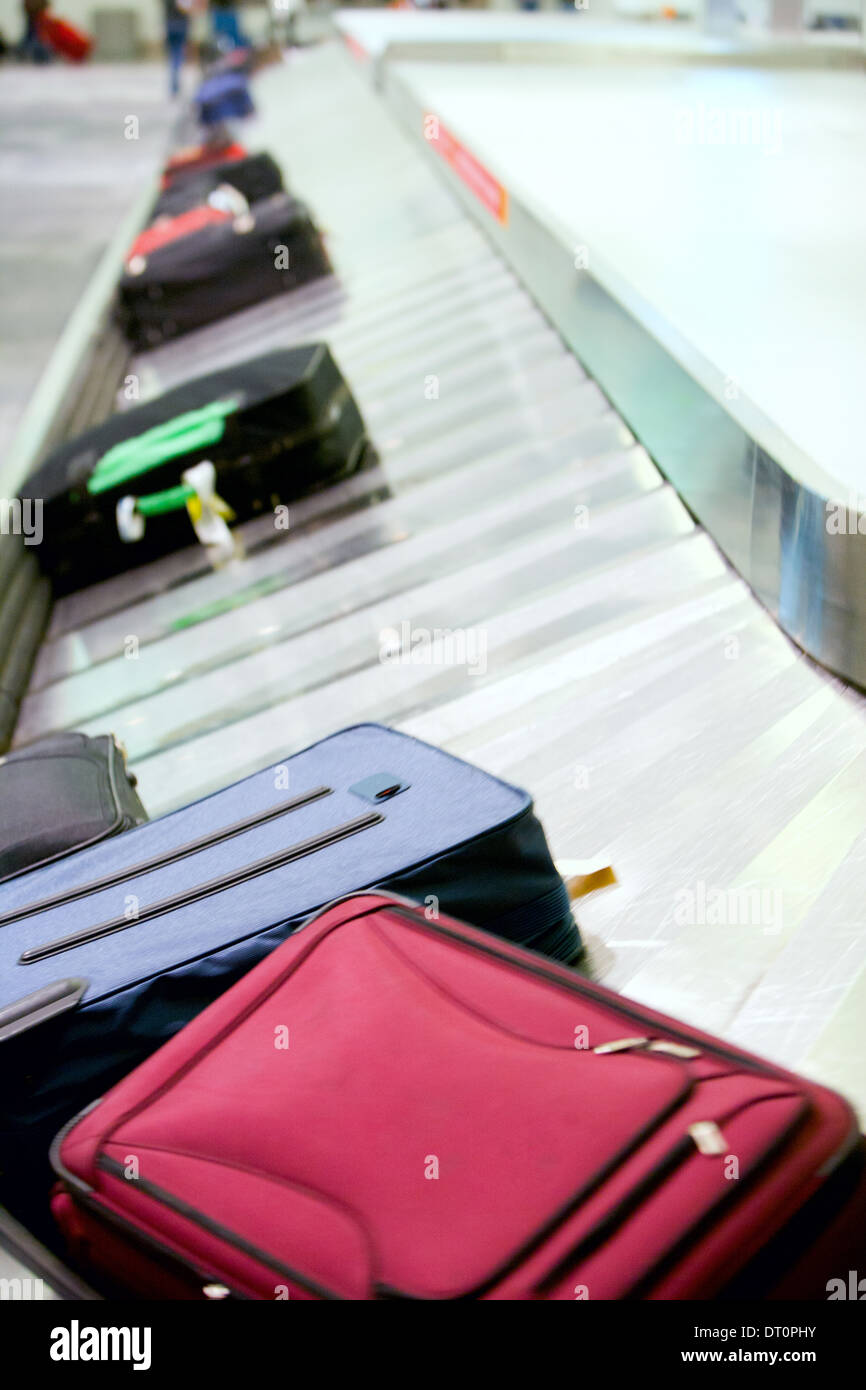 Luggage on an airport arrival carousel Stock Photo - Alamy