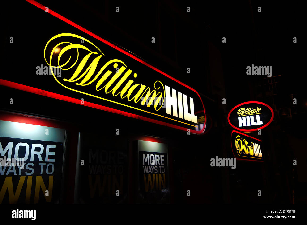 William Hill Betting Shop Sign Illuminated At Night, UK Stock Photo - Alamy