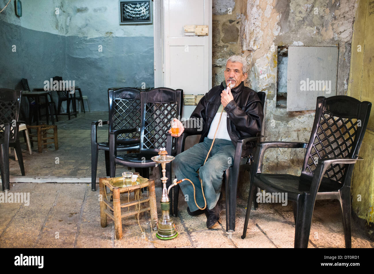 Man smoking shisha (water pipe) in a cafe in the Old City, Jerusalem ...