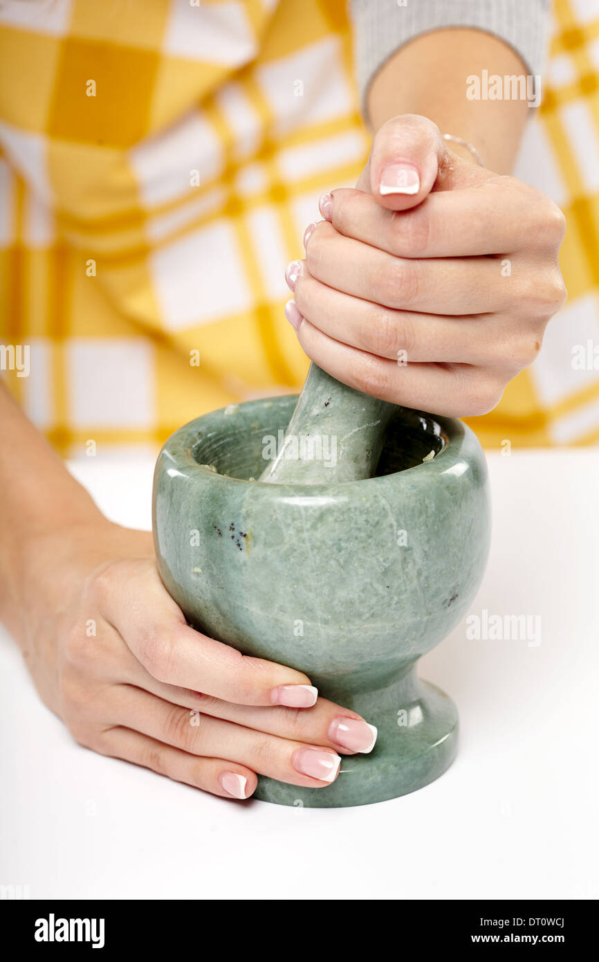 Closeup of crushing the garlic cloves in a granite mortar, selective ...