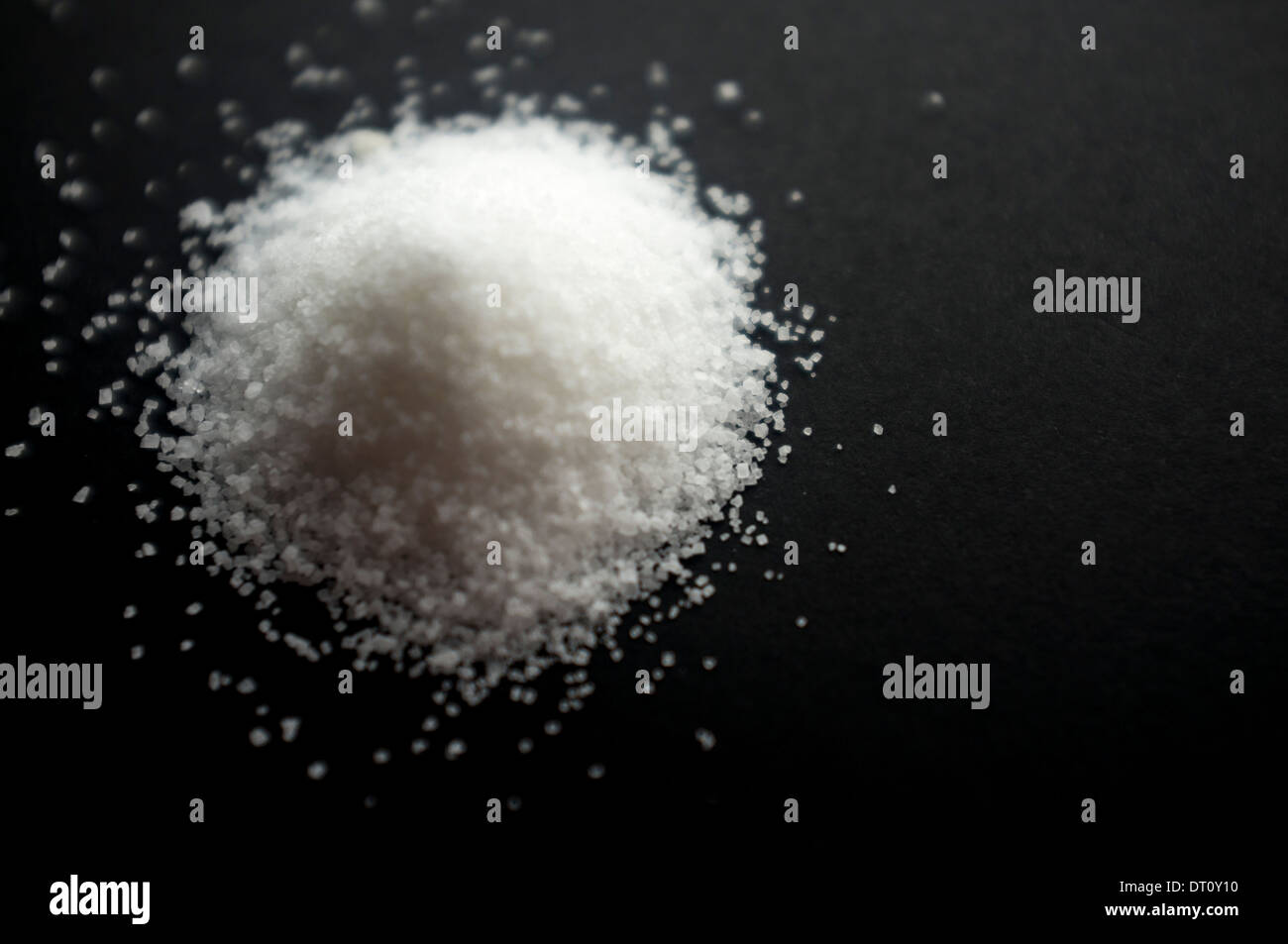 sugar granules arranged and scattered close up macro Stock Photo - Alamy