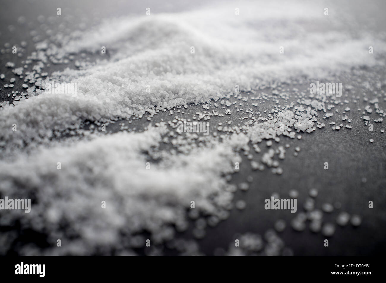 sugar granules arranged and scattered close up macro Stock Photo - Alamy