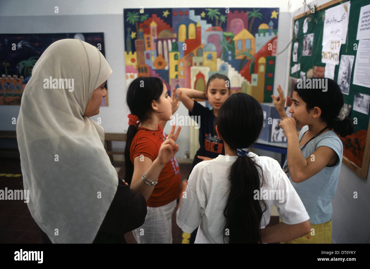 An Israeli Arab teacher watching young Jewish and Arab schoolgirls ...