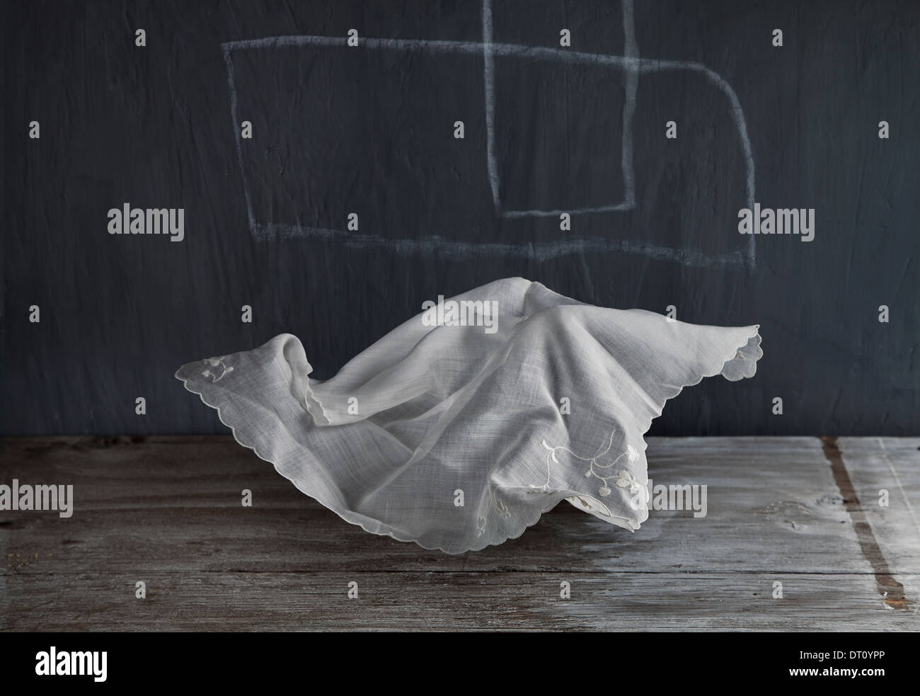 Table cloth above wooden table, black wall in background Stock Photo ...