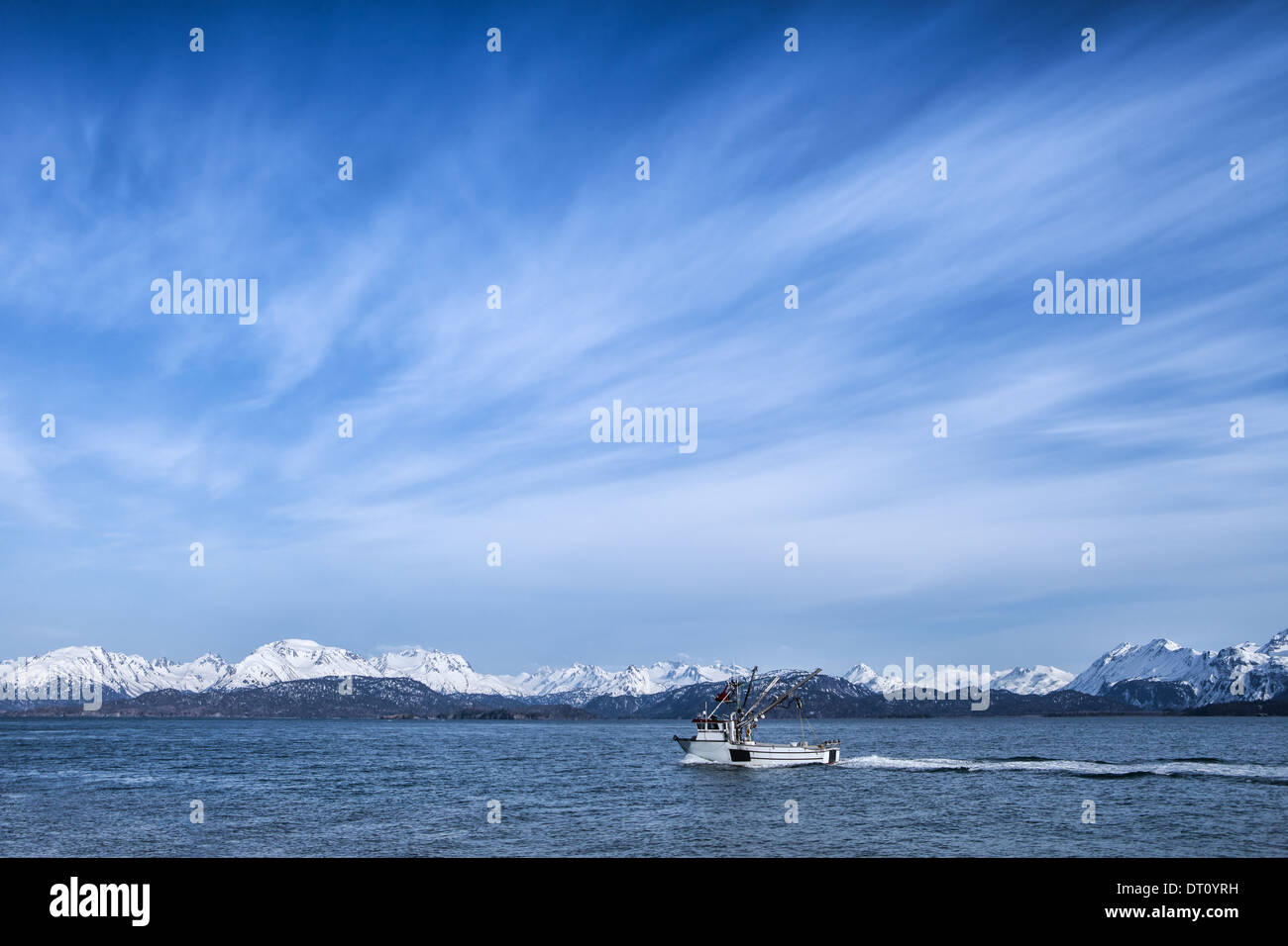 Small fishing trawler moving through the Kachemak Bay near Homer Alaska ...