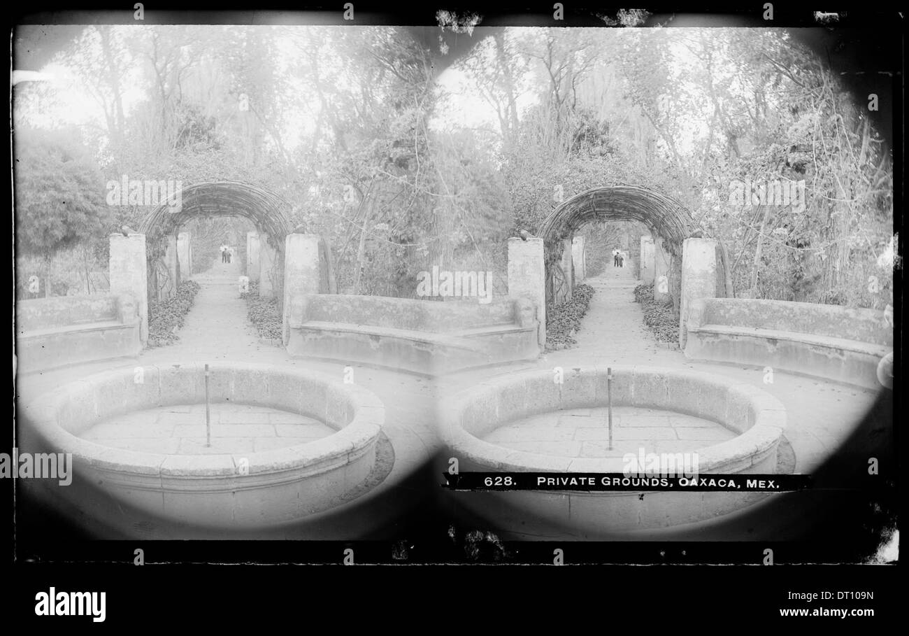 Empty stone fountain in a large private garden, Oaxaca, Mexico, ca.1900 ...