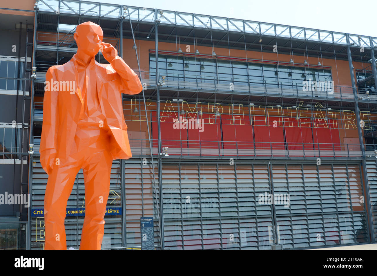 Giant orange statue of man on mobile phone, L'amphitheatre, cité ...