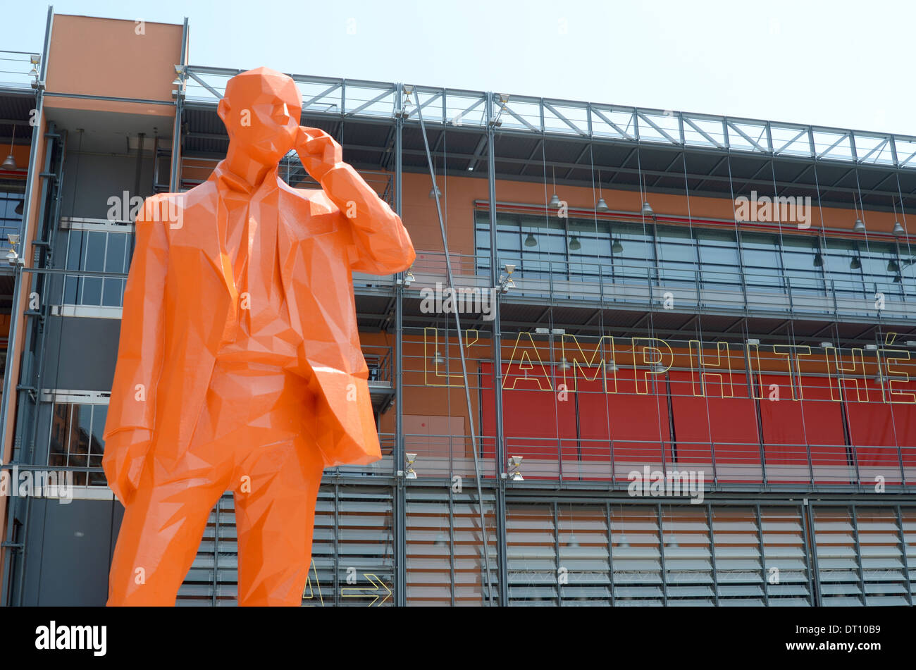 Giant orange statue of man on mobile phone, L'amphitheatre, cité ...