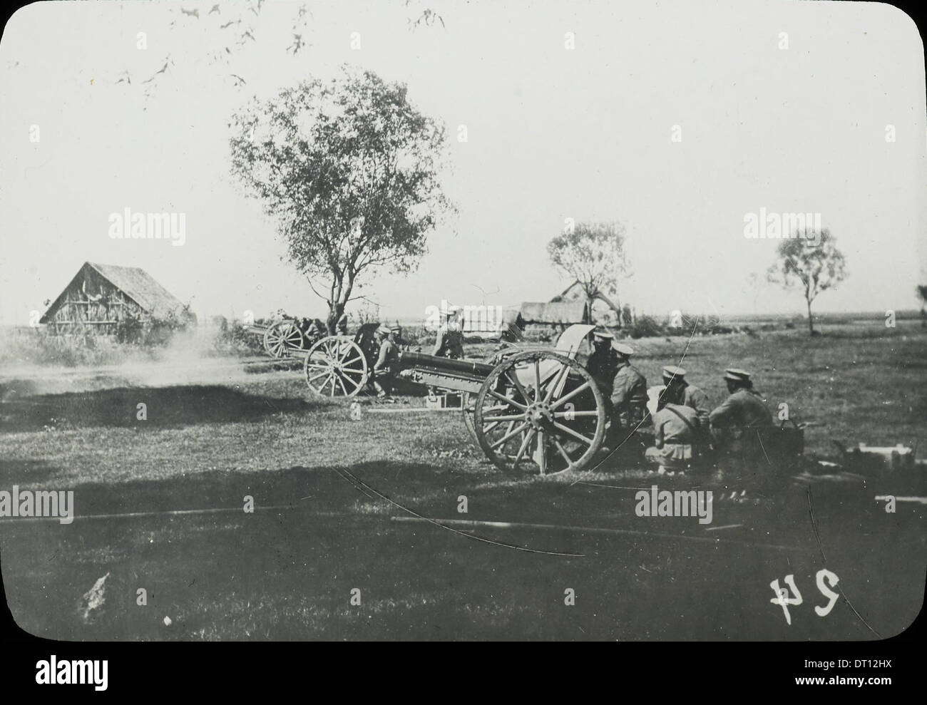 A photograph from 1911 showing the firing of guns in China, reflecting ...