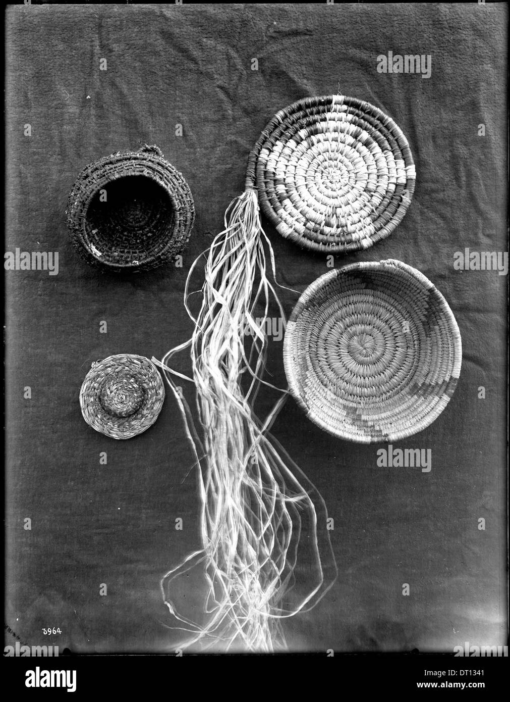 A photograph showing four unidentified Indian baskets on display ...