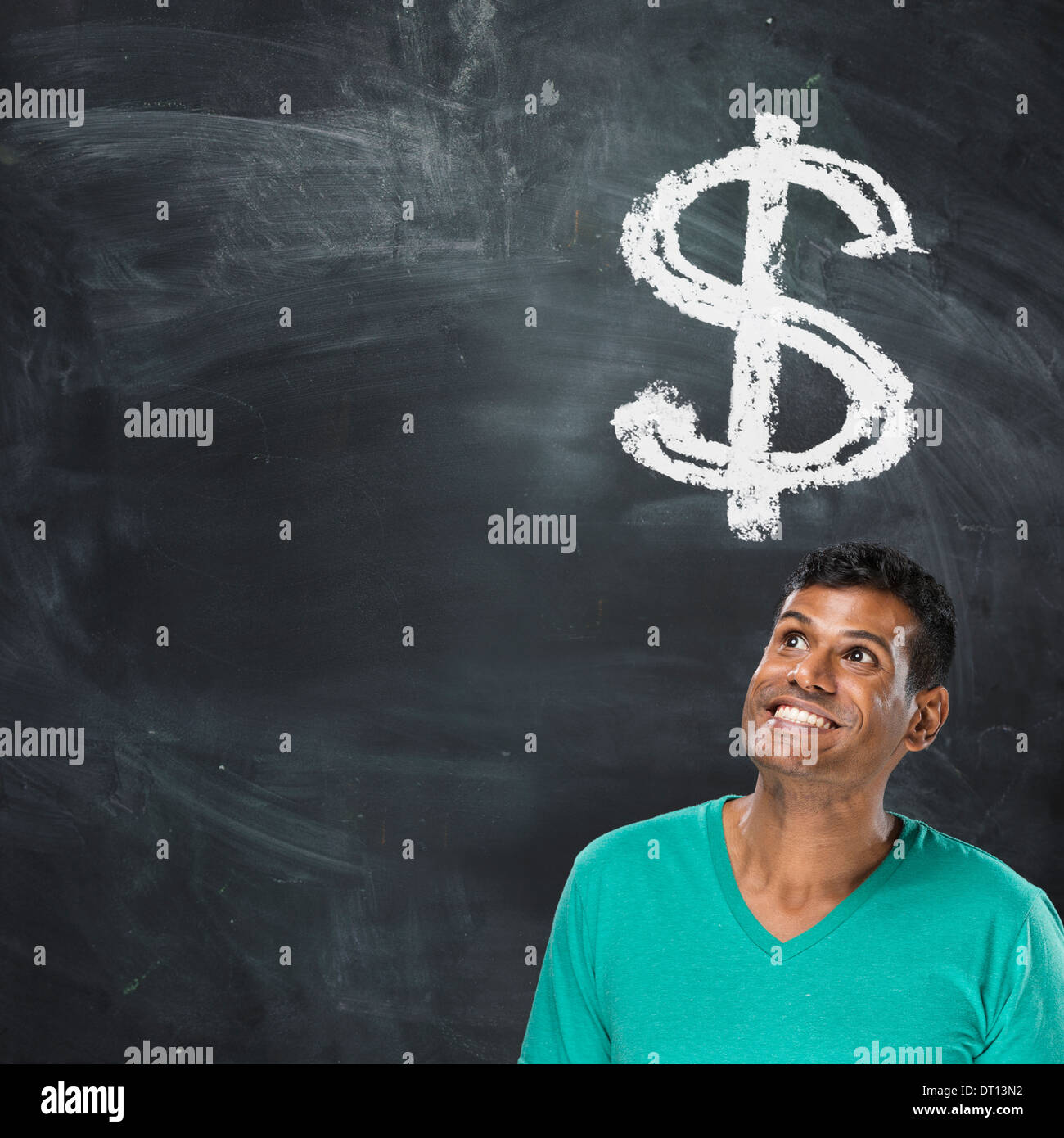 Happy Indian man standing in front of dollar sign written on a ...