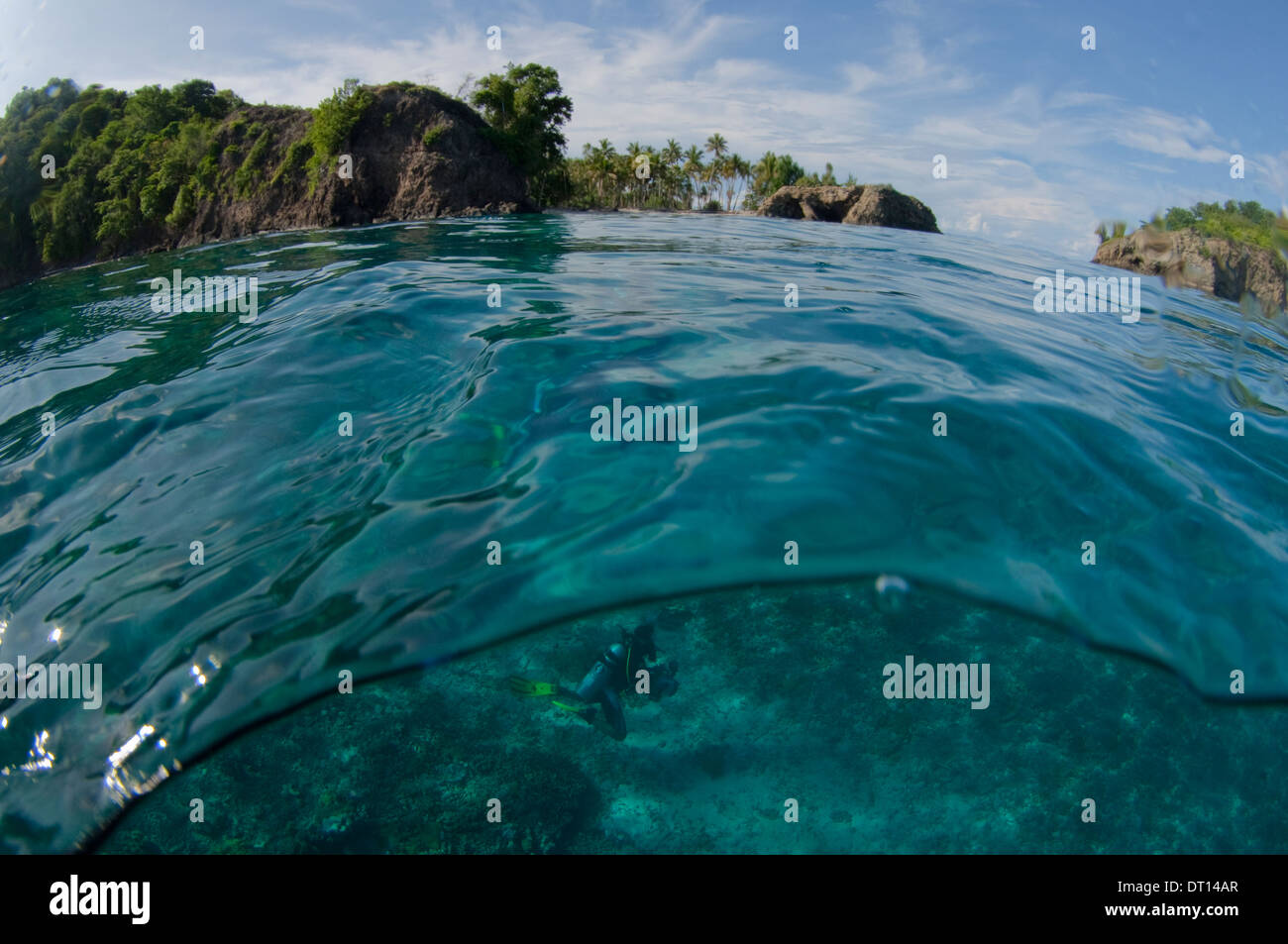 Half and half with island and scuba diver, Cliff and Caves, Halmahera ...