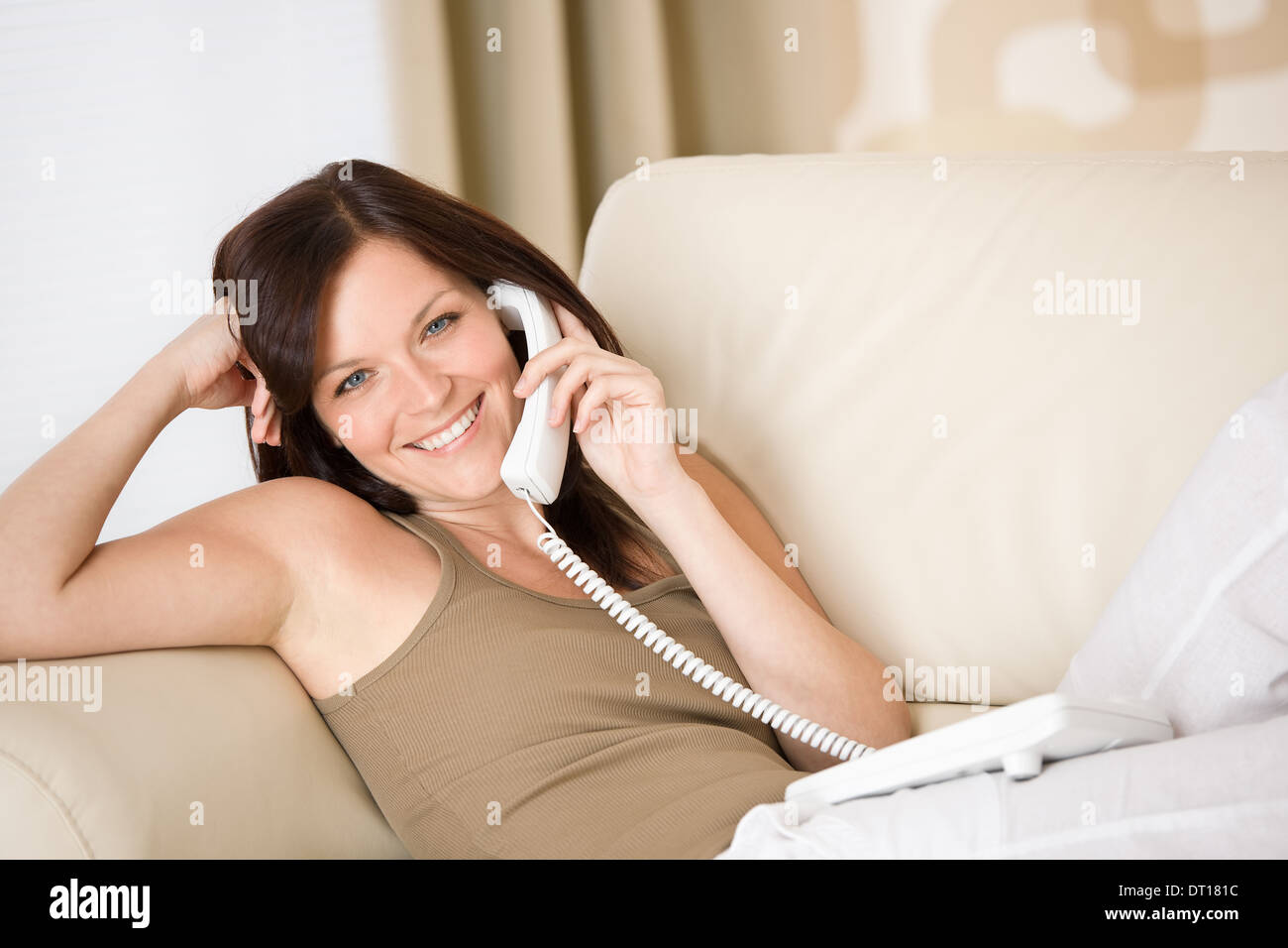 On the phone home: young woman calling Stock Photo - Alamy