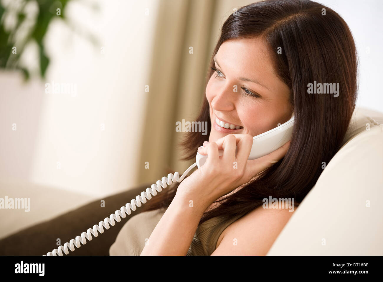 On the phone home: woman calling Stock Photo - Alamy