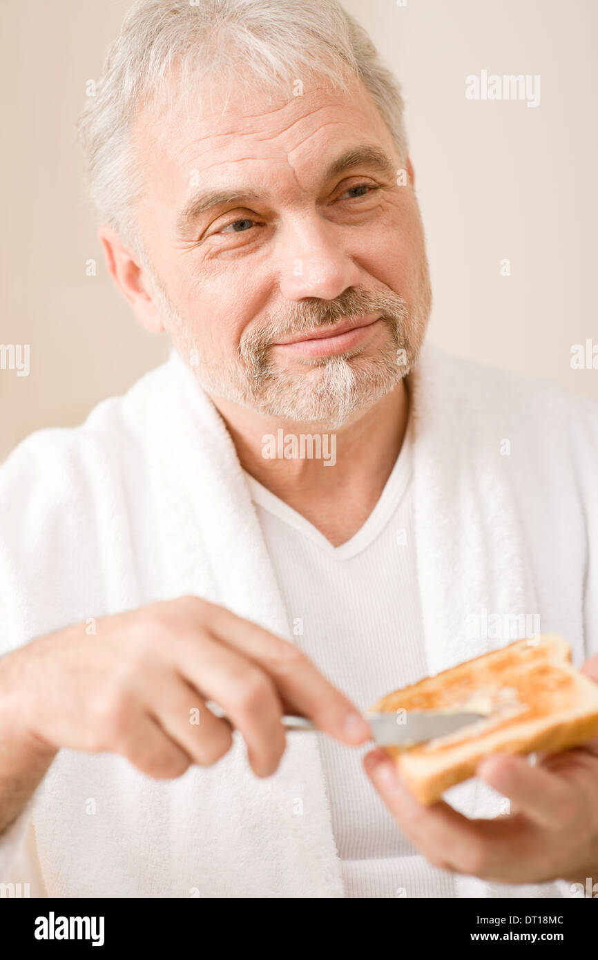 Senior mature man having breakfast toast Stock Photo - Alamy