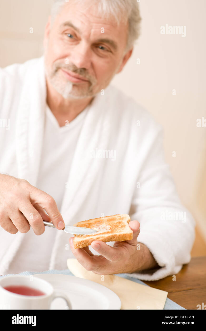 Older man eating toast bread hi-res stock photography and images - Alamy