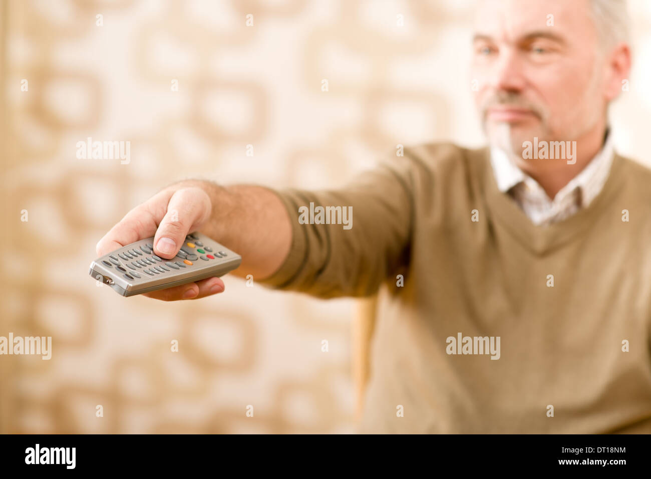Senior mature man with remote control Stock Photo - Alamy