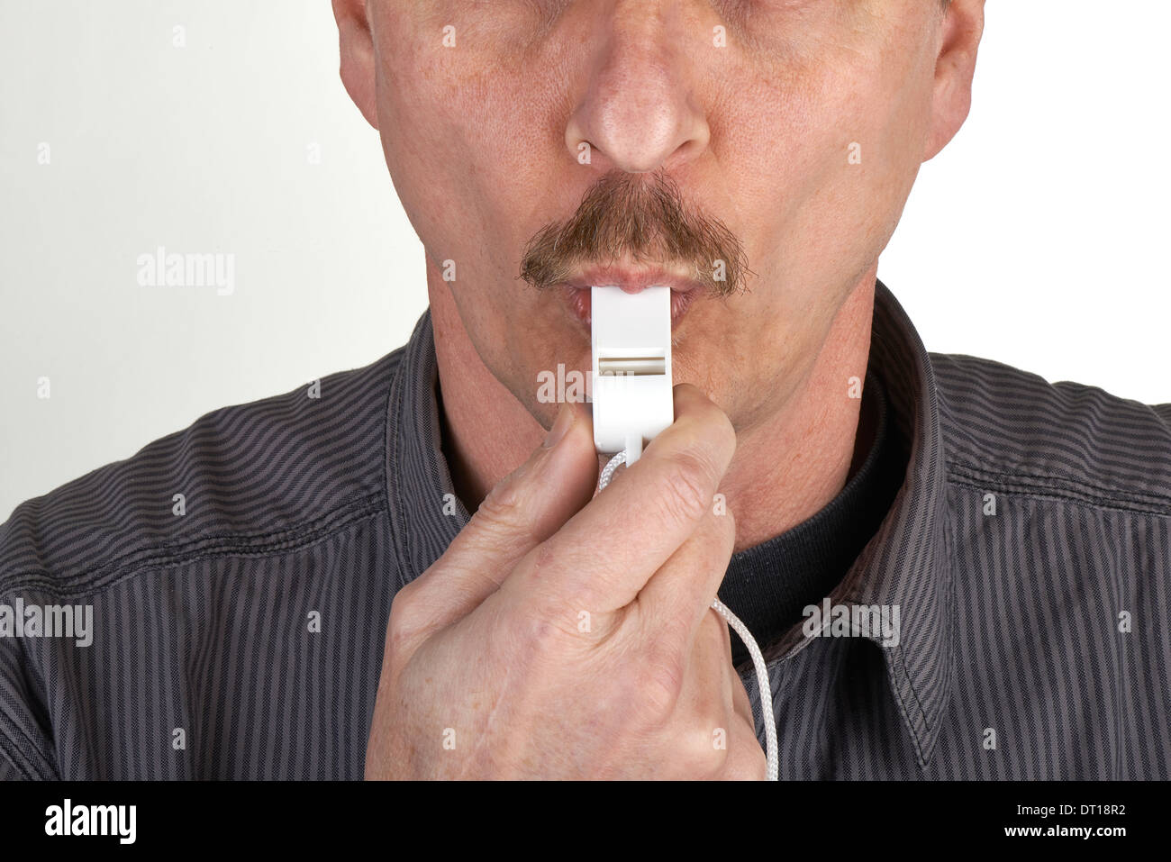 Close up of a referee blowing a whistle Stock Photo - Alamy