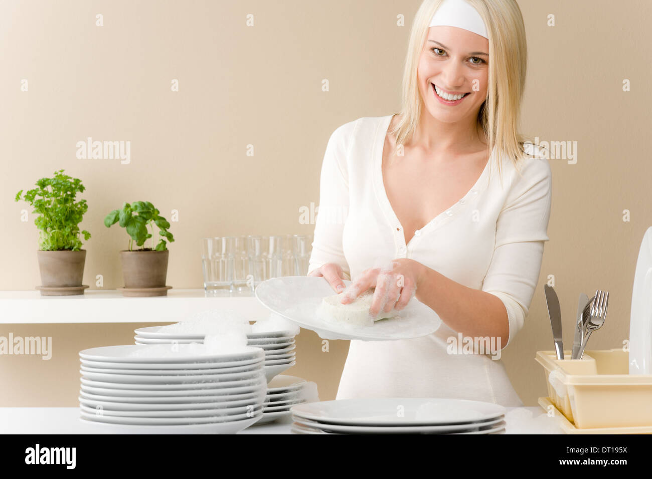 Modern kitchen - happy woman washing dishes Stock Photo - Alamy