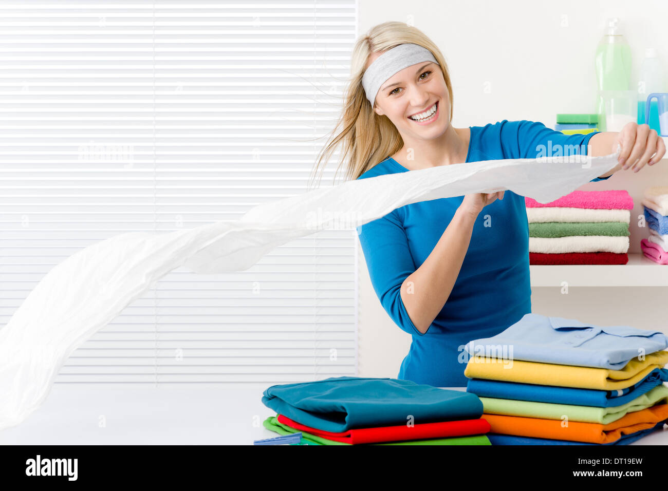Laundry - woman folding clothes Stock Photo - Alamy
