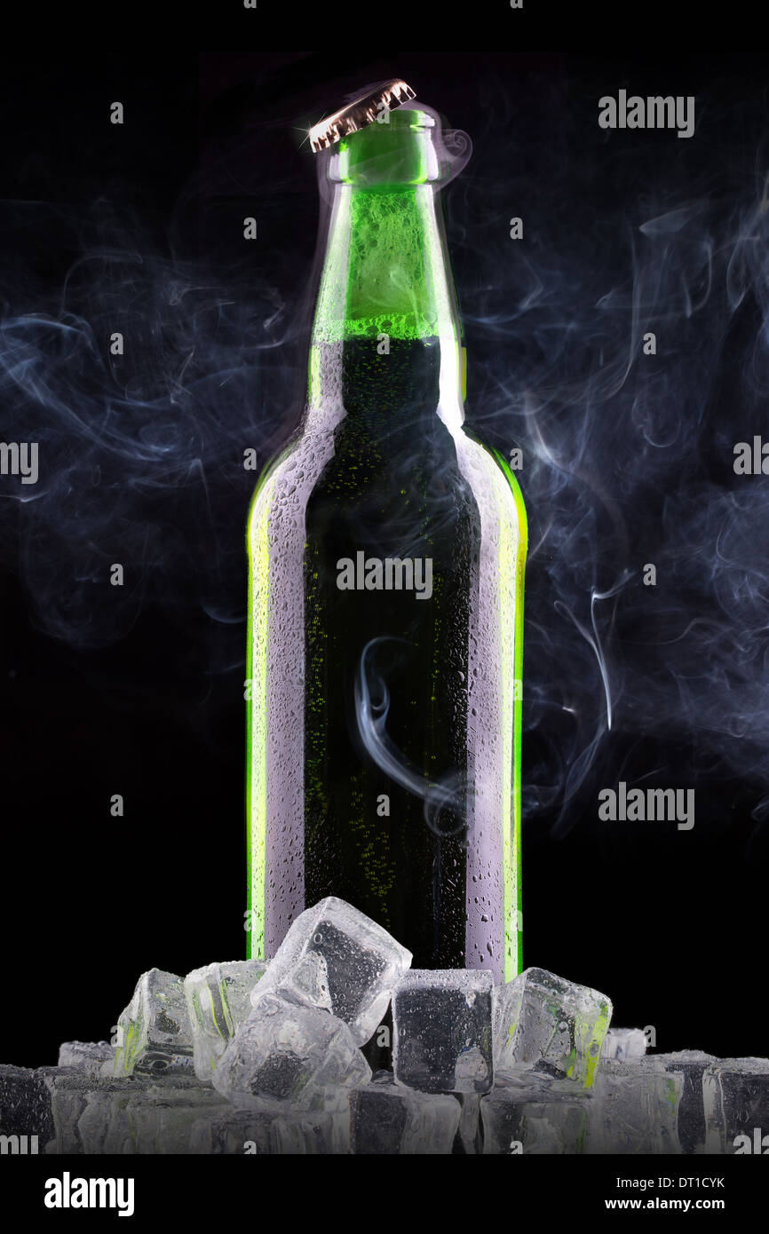 Beer bottle with ice and chill smoke Stock Photo - Alamy