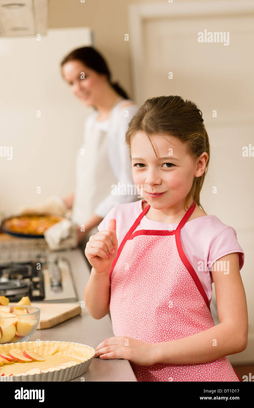 Young girl baking apple pie thumb up Stock Photo - Alamy
